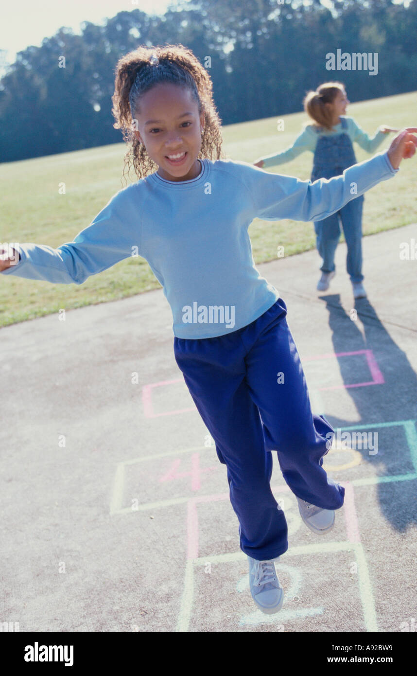 Two girls playing hopscotch hi-res stock photography and images - Alamy