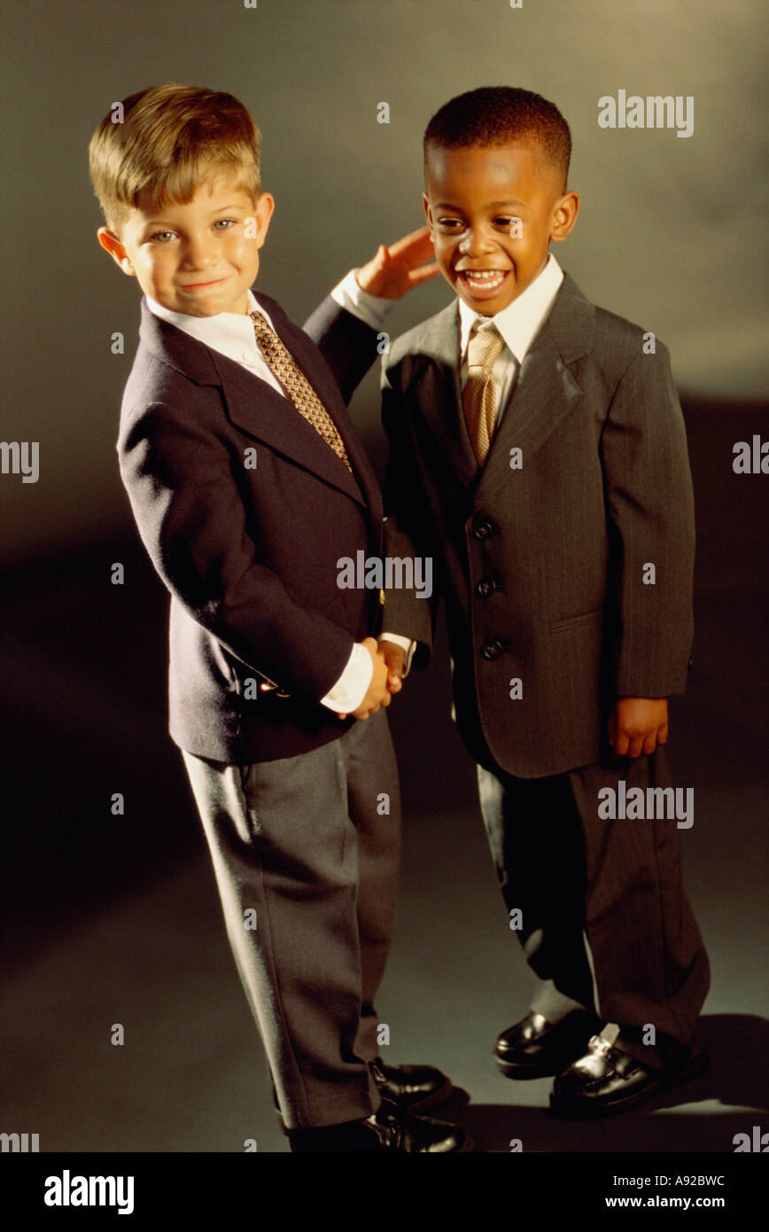 Portrait of two boys dressed as businessmen shaking hands Stock Photo ...