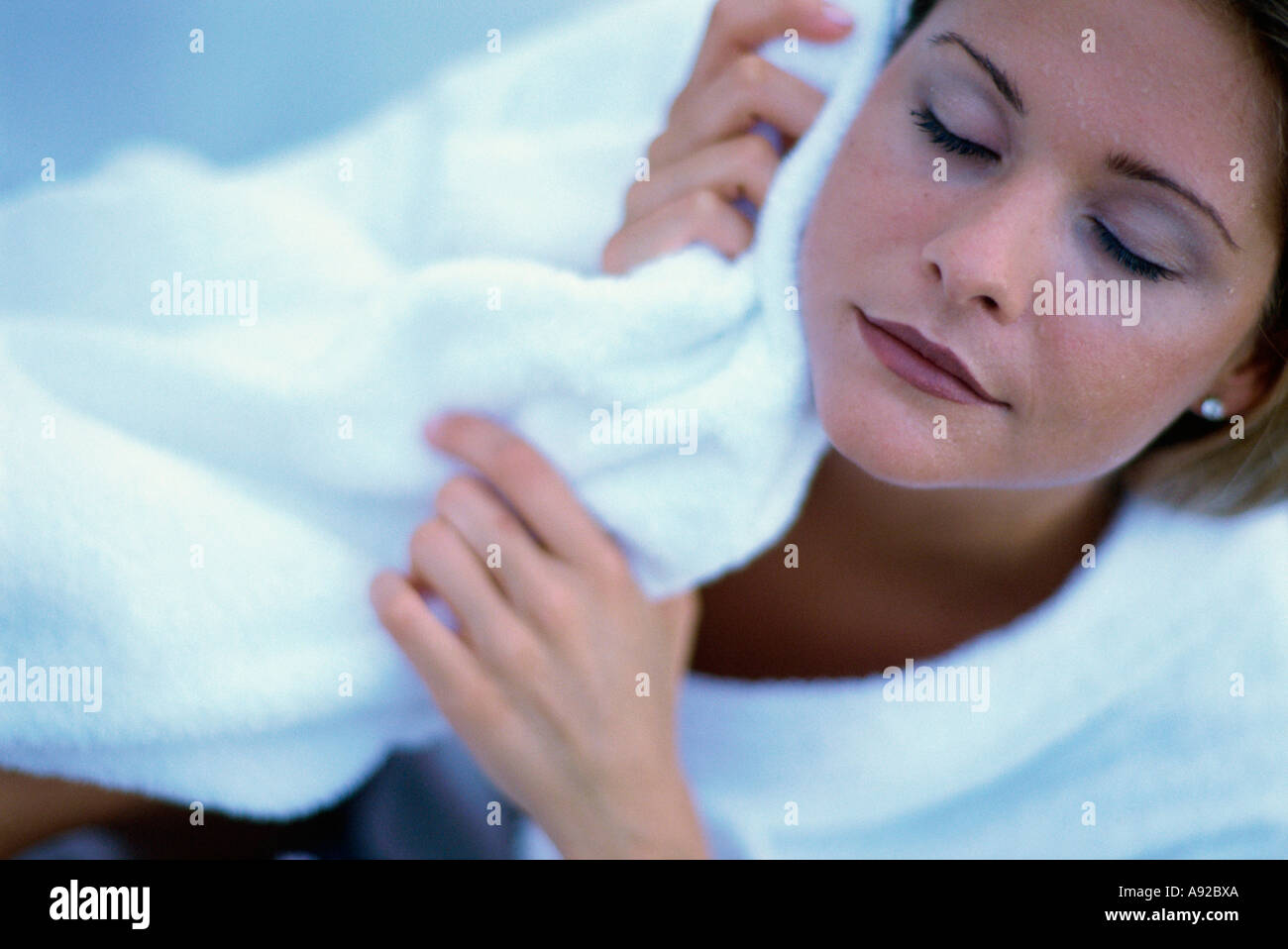 Woman wiping her face with a towel hi-res stock photography and images ...