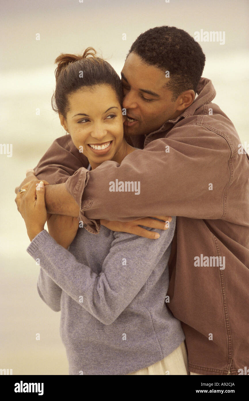 Young couple stand embracing by the sea hi-res stock photography and ...