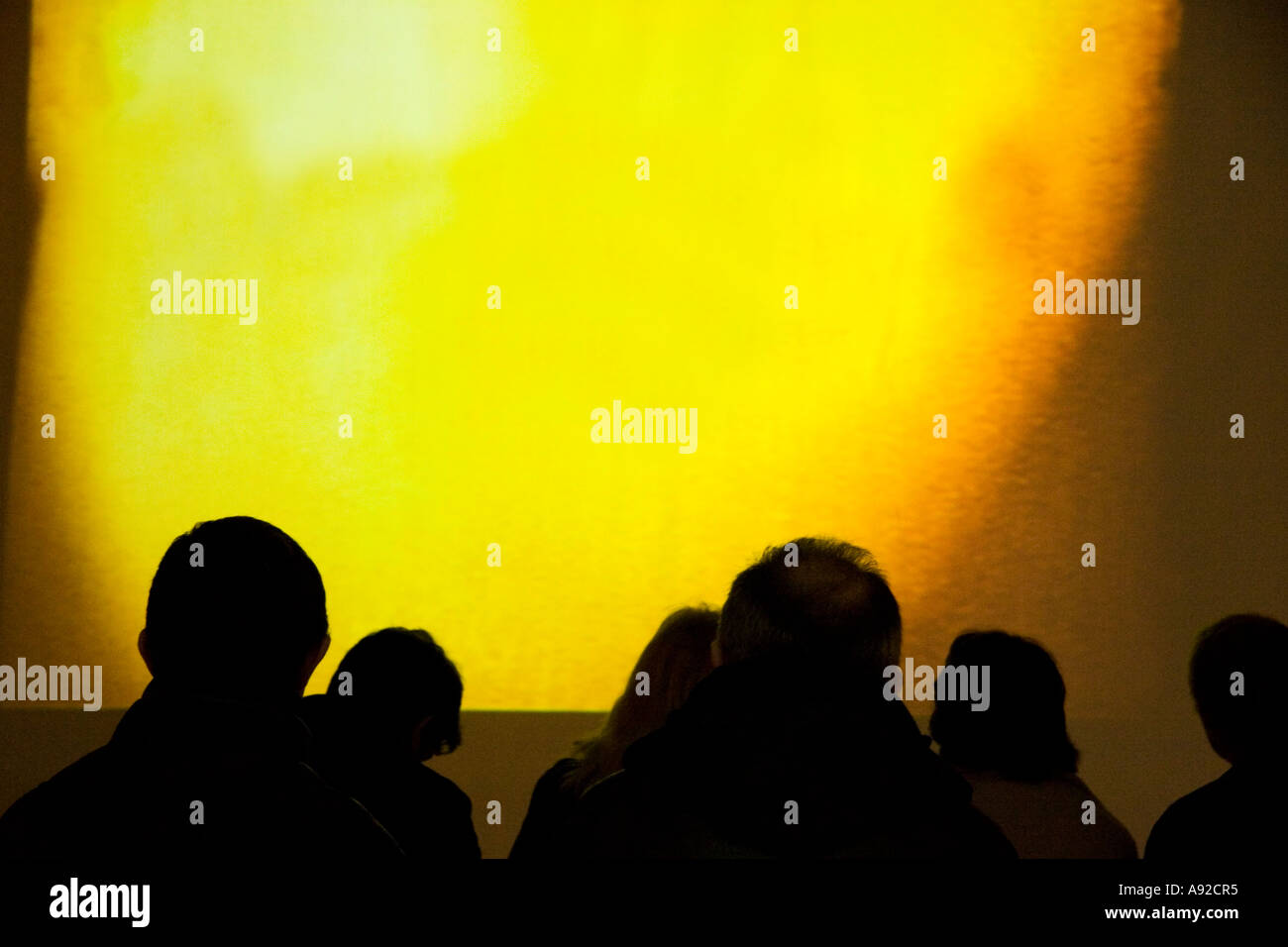 Audience watching a projection screen Stock Photo - Alamy