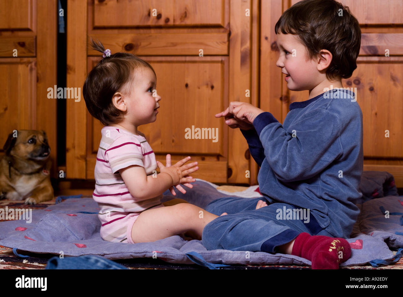 Sister and brother singing and playing Stock Photo - Alamy