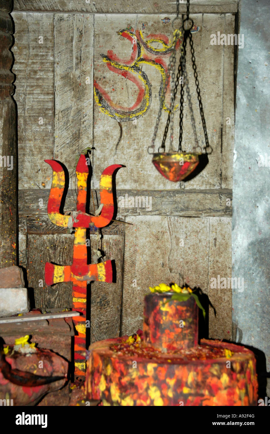 Shrine for god Shiva with a lingam and trisul red yellow and orange ...