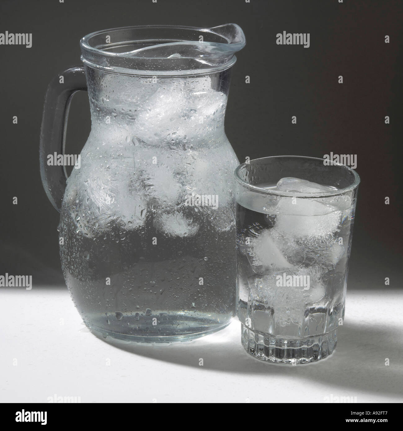 Glass and jug of ice water Stock Photo - Alamy