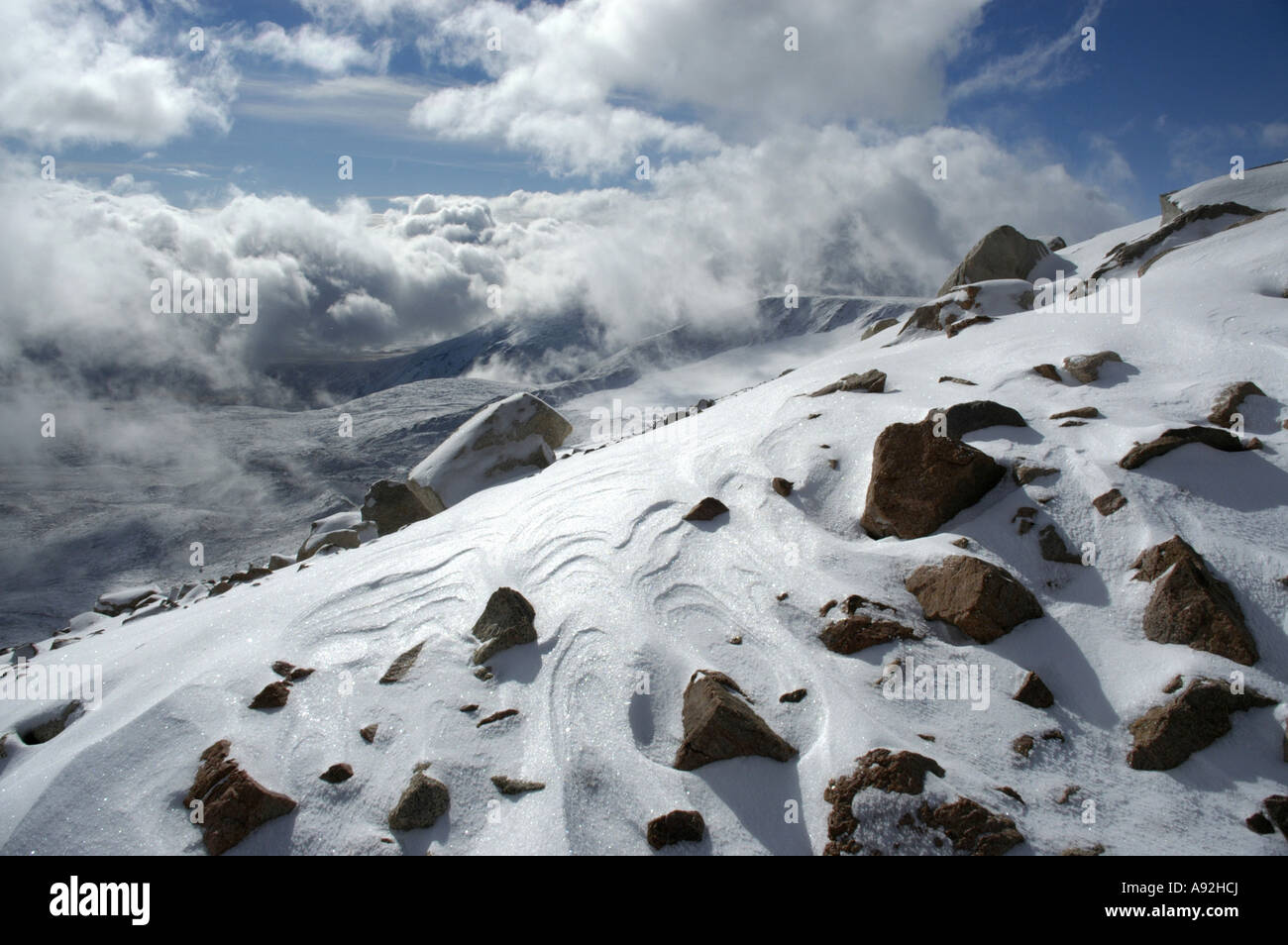 Fresh snow on boulders with clouds and sun on mountains Kharkhiraa ...