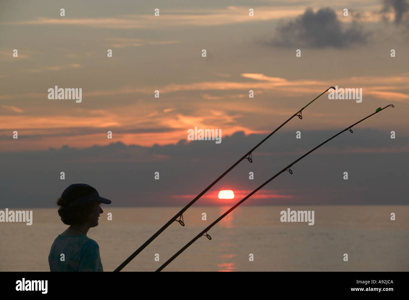 Woman fishing off beach hi-res stock photography and images - Alamy