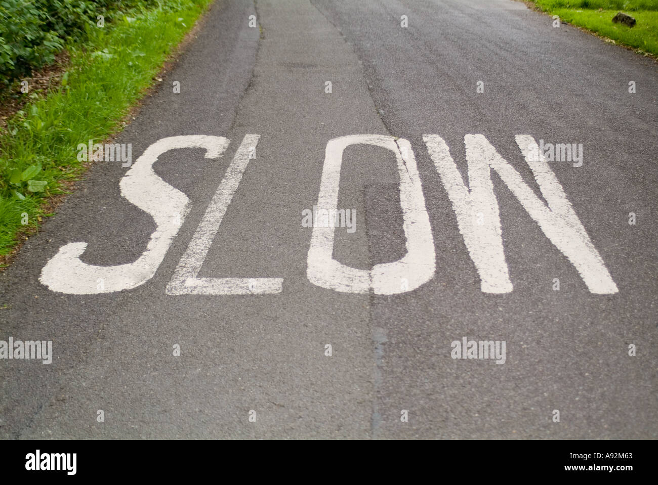 slow sign painted on road Stock Photo - Alamy