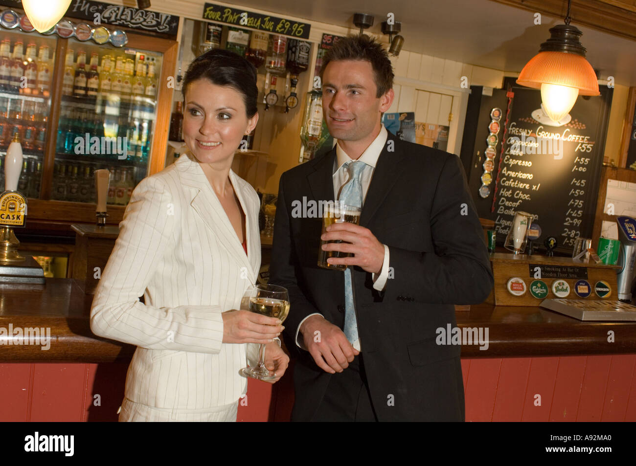 couple having a drink in a bar and chatting Stock Photo - Alamy