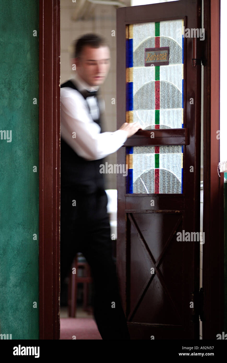 Waiter Coming Through the Kitchen Door of a Busy Restaurant, Motion ...