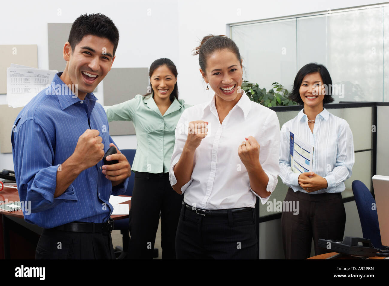 Asian businesspeople cheering in office Stock Photo - Alamy