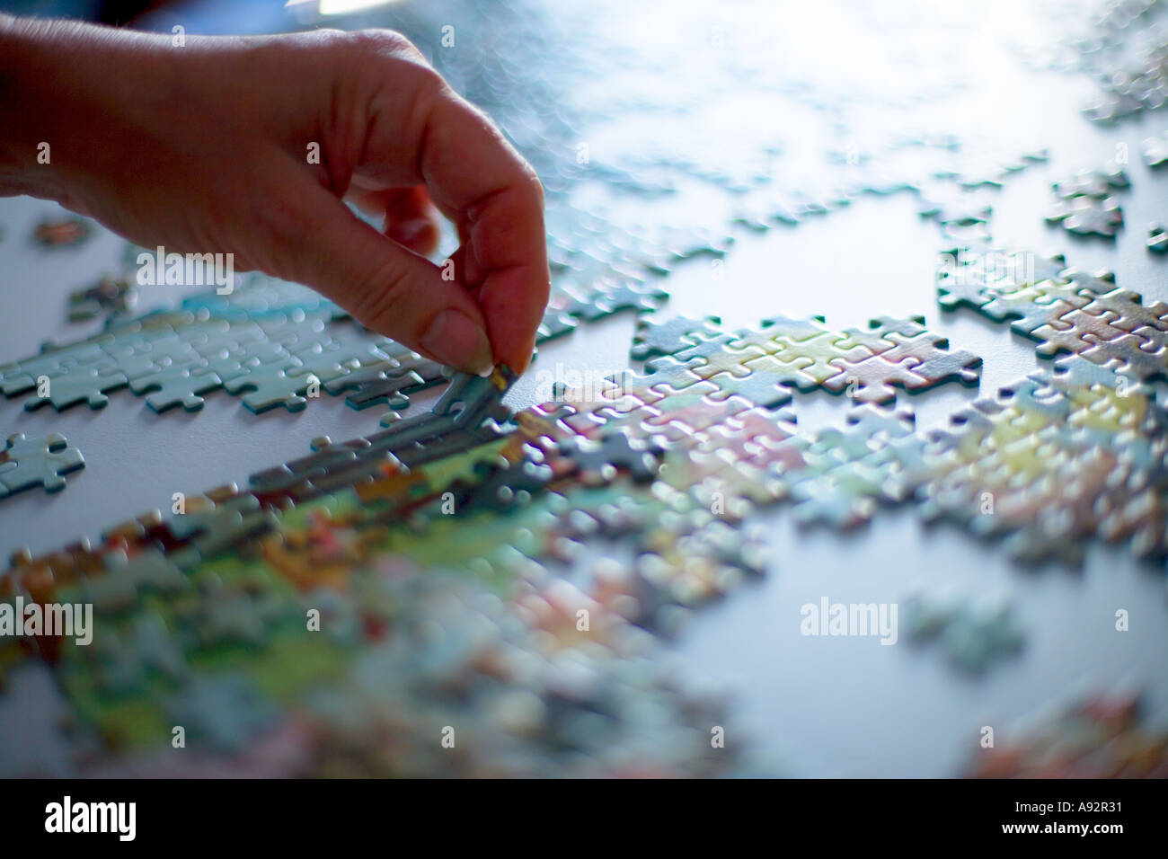 Person doing jigsaw hi-res stock photography and images - Alamy