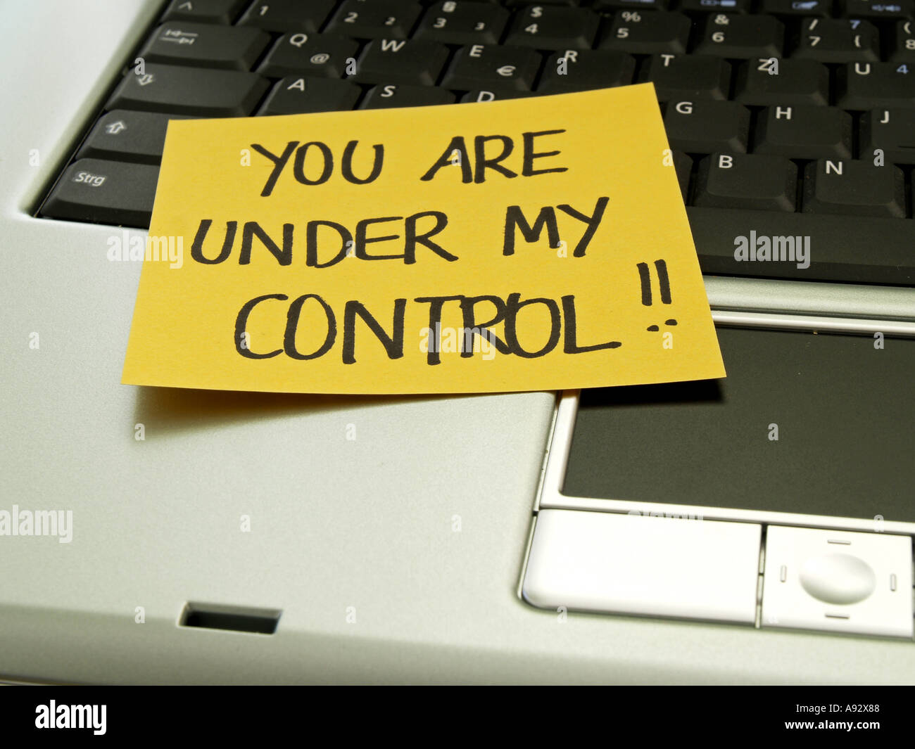 memo note on notebook, You are under my control Stock Photo - Alamy