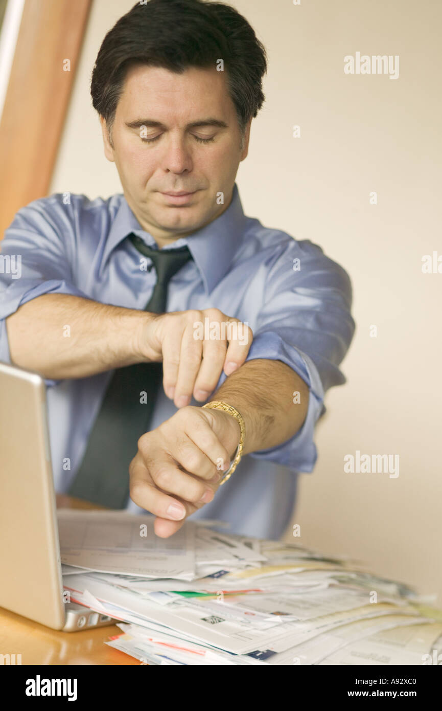 Late 40s Caucasian male businessman rolling up sleeves Stock Photo - Alamy