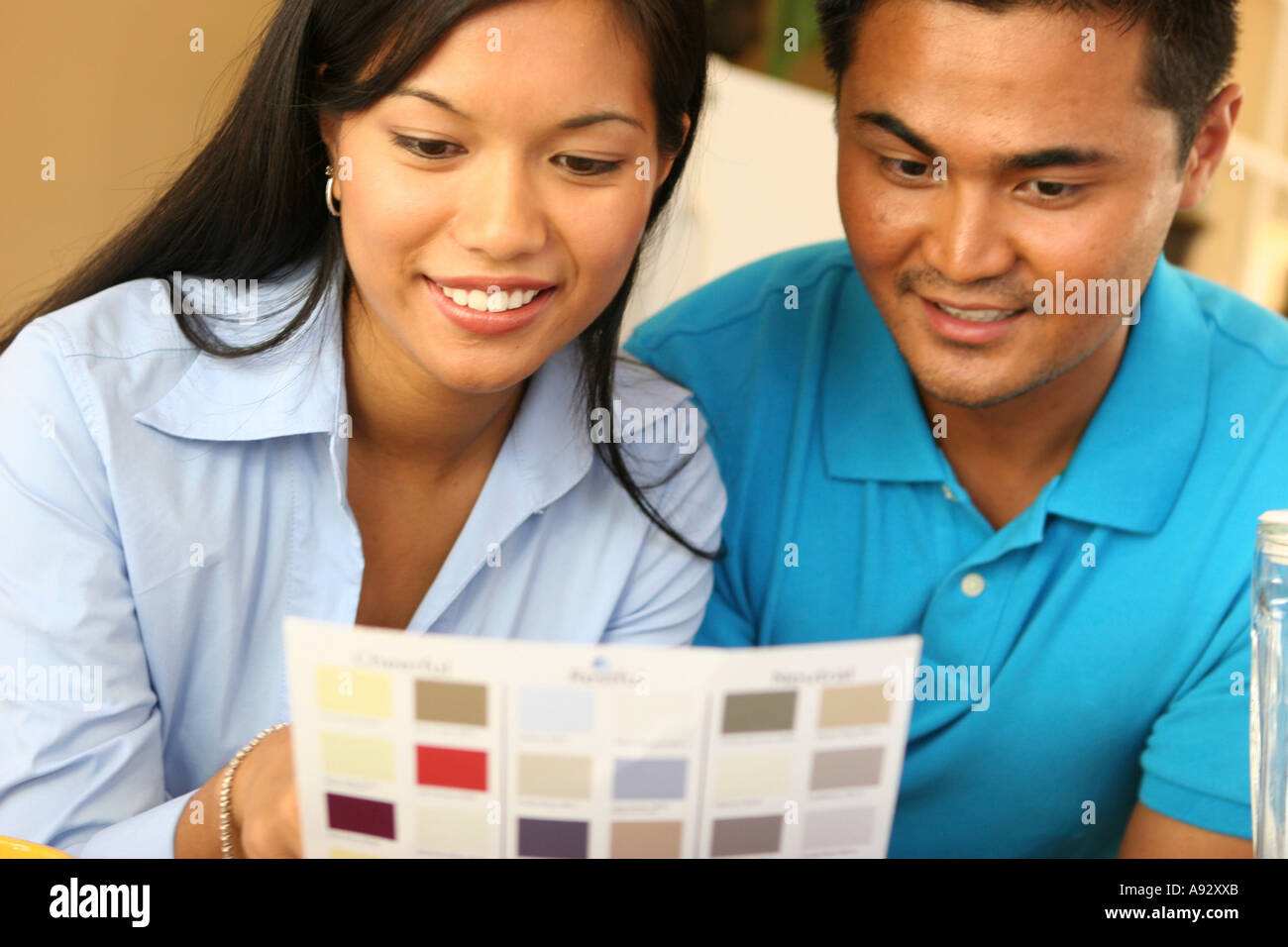 Close-up of a young couple choosing color from a color swatch Stock ...