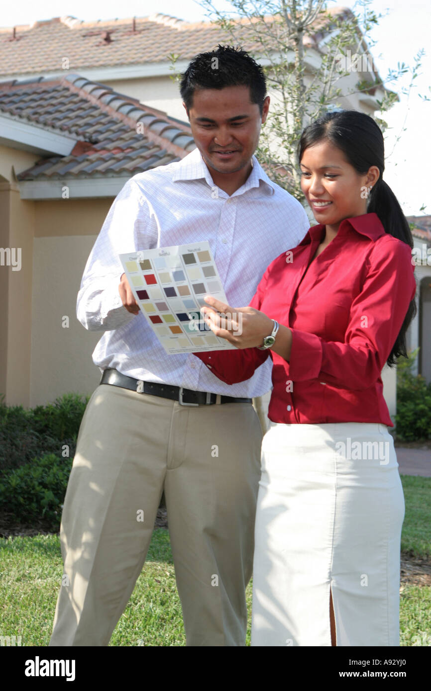 Young couple choosing color from a color swatch Stock Photo - Alamy
