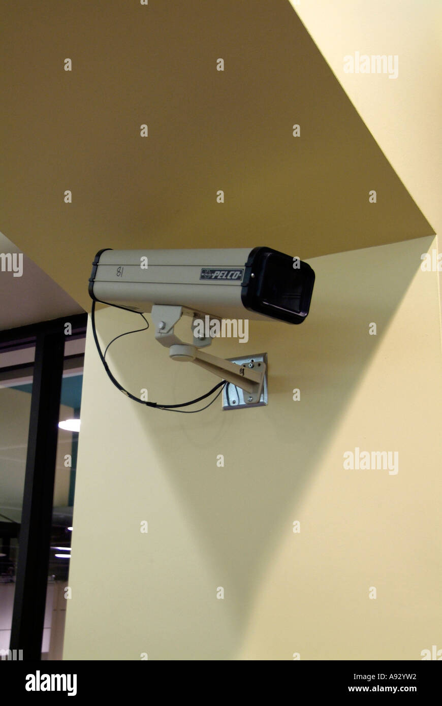Surveillance security camera mounted against a wall Stock Photo - Alamy