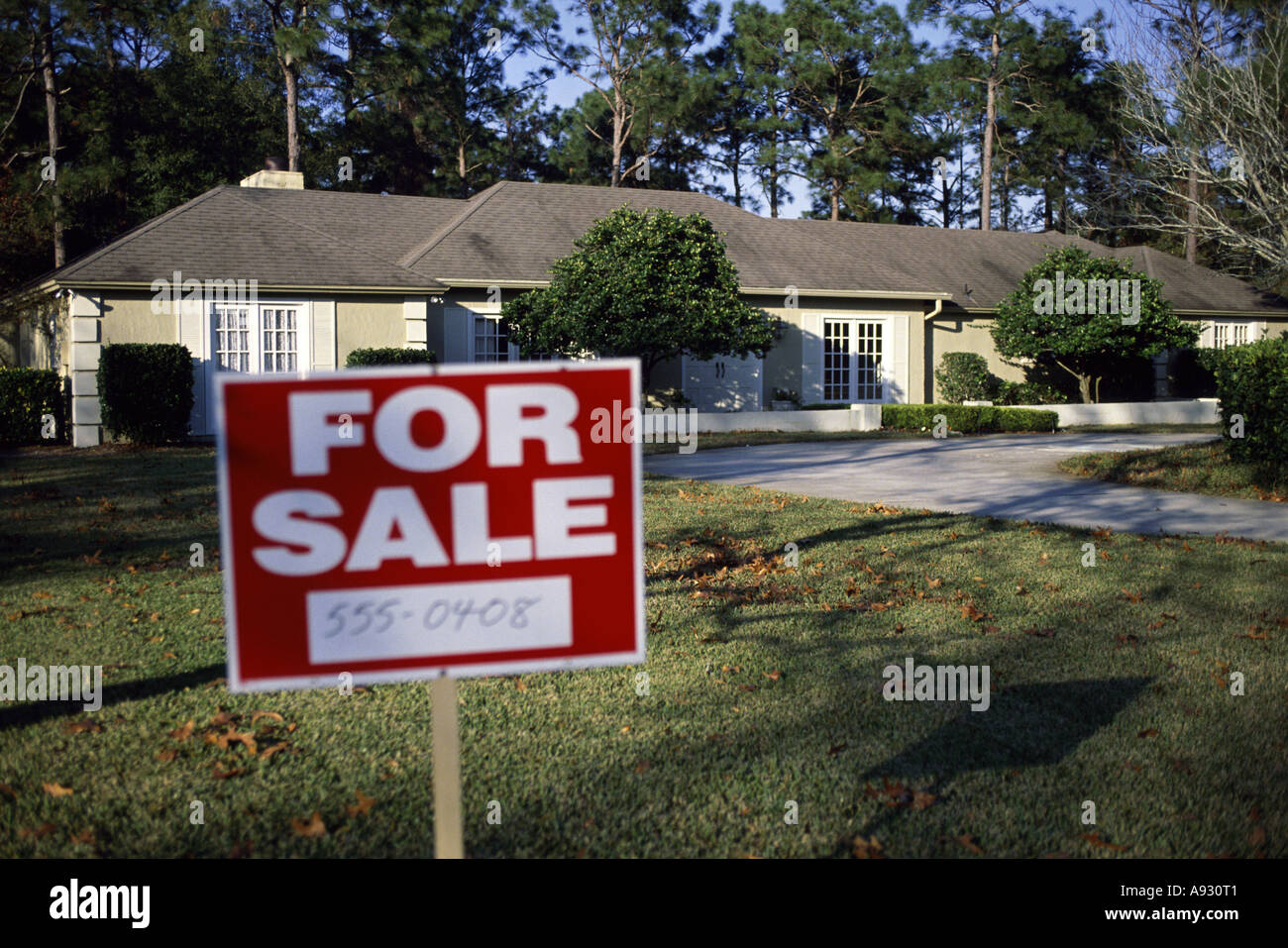 For sale sign board in the front yard of a house Stock Photo - Alamy