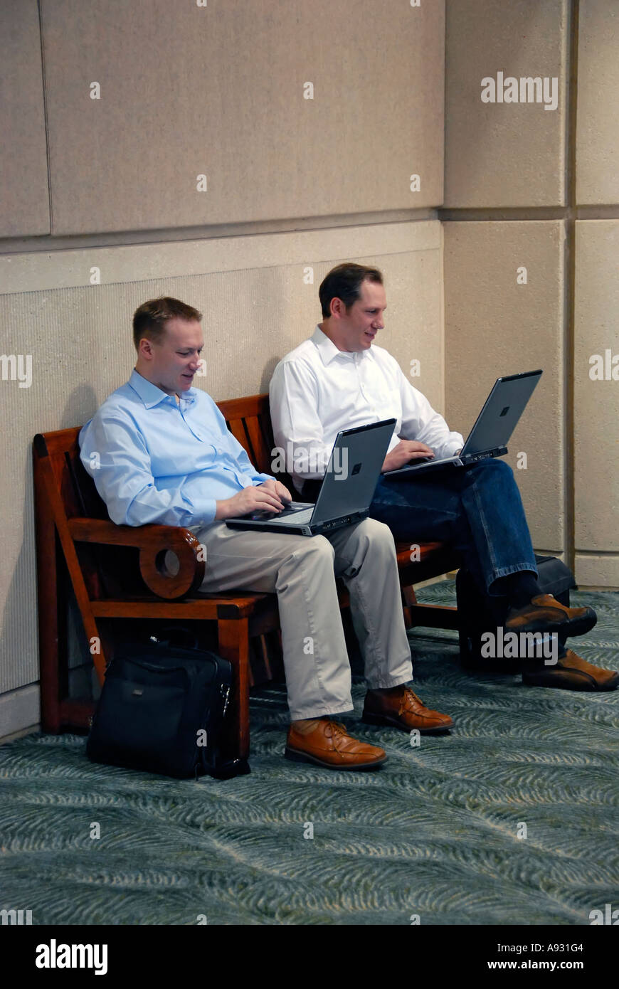 Adult businessman professional works on wireless laptop computer while ...