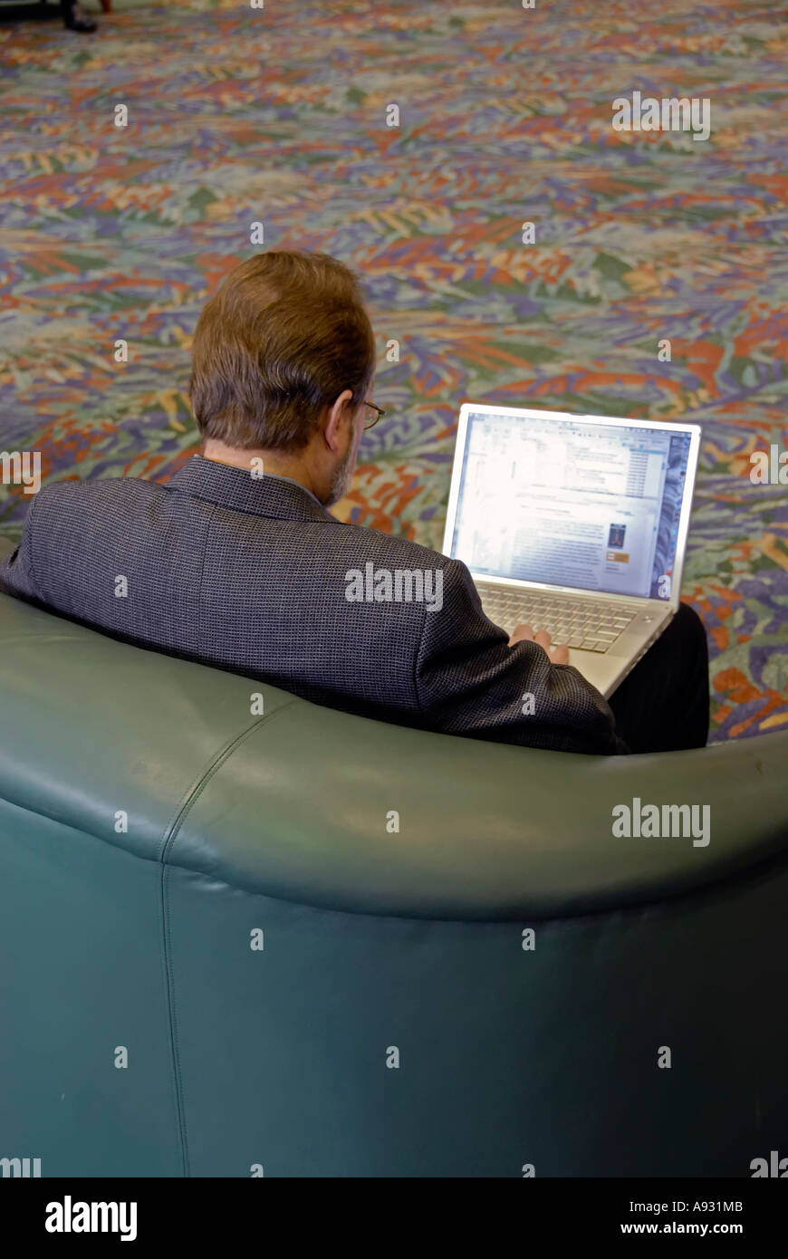 Adult businessman professional works on wireless laptop computer while ...