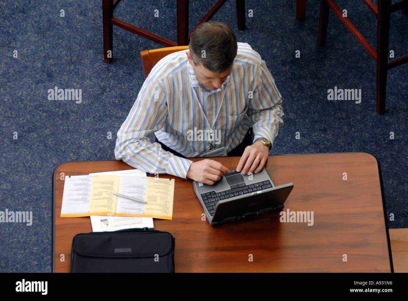 Adult businessman professional works on wireless laptop computer while ...
