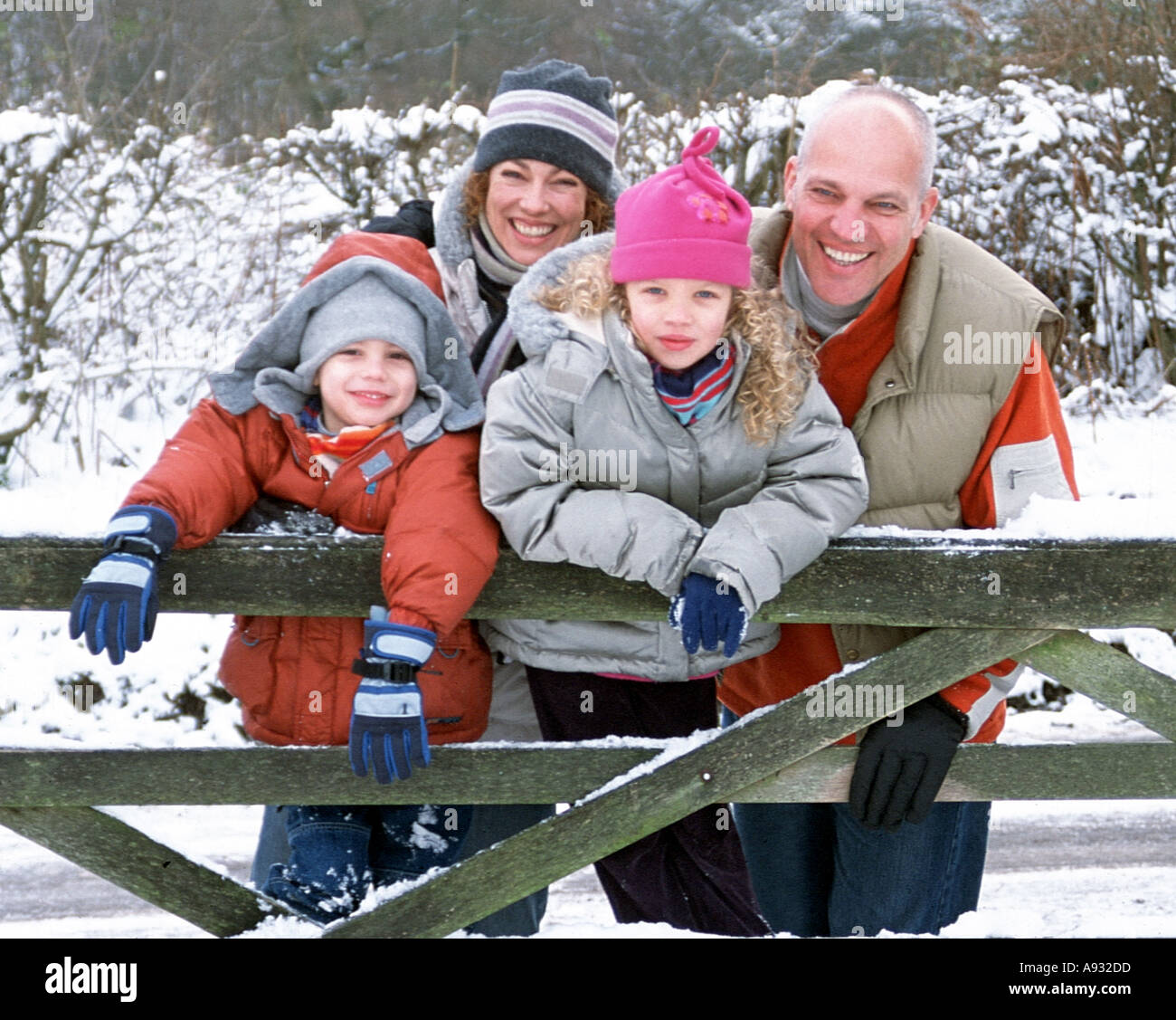 Family Leaning Over Farm Gate Stock Photo - Alamy