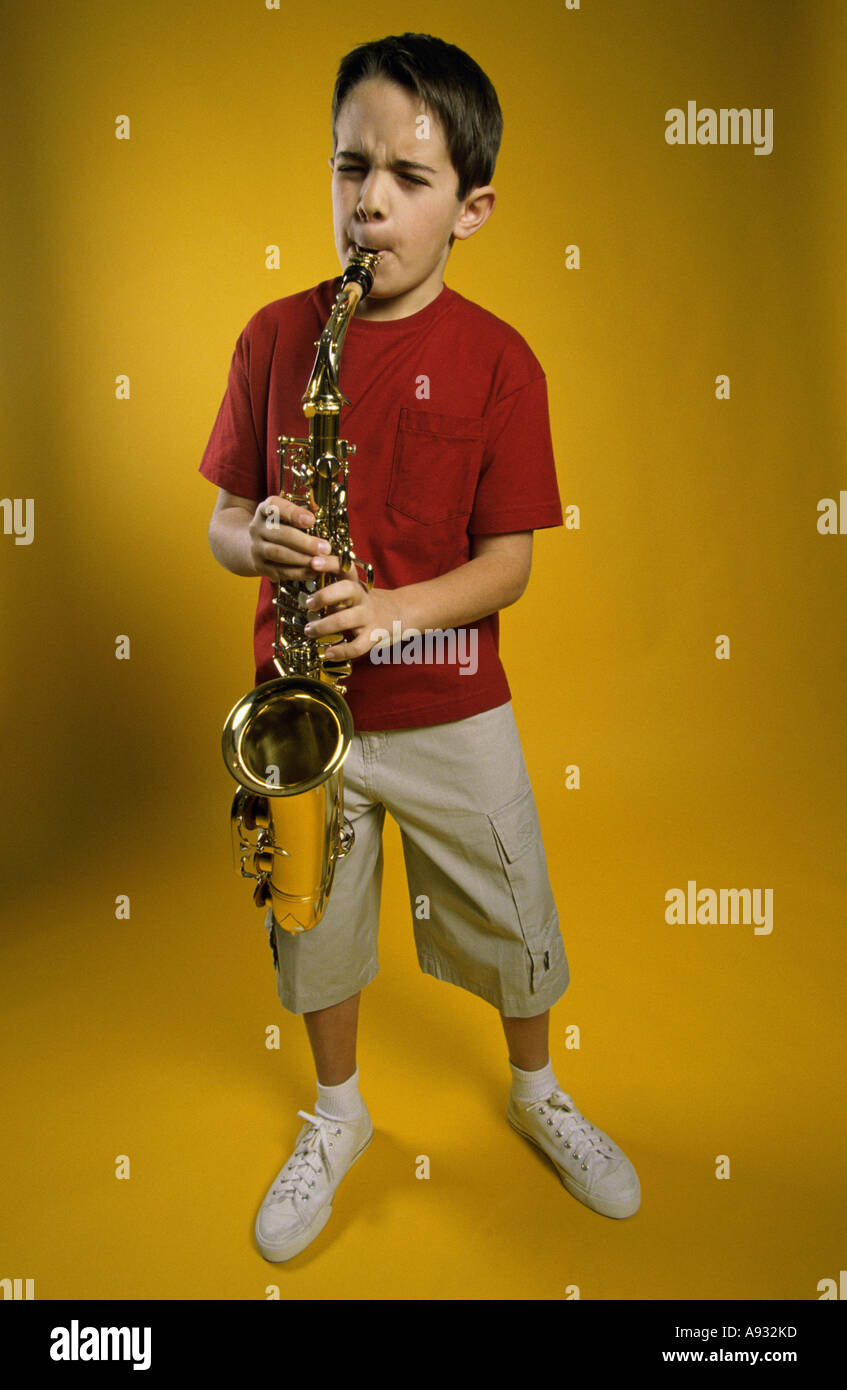 Boy playing a saxophone hi-res stock photography and images - Alamy