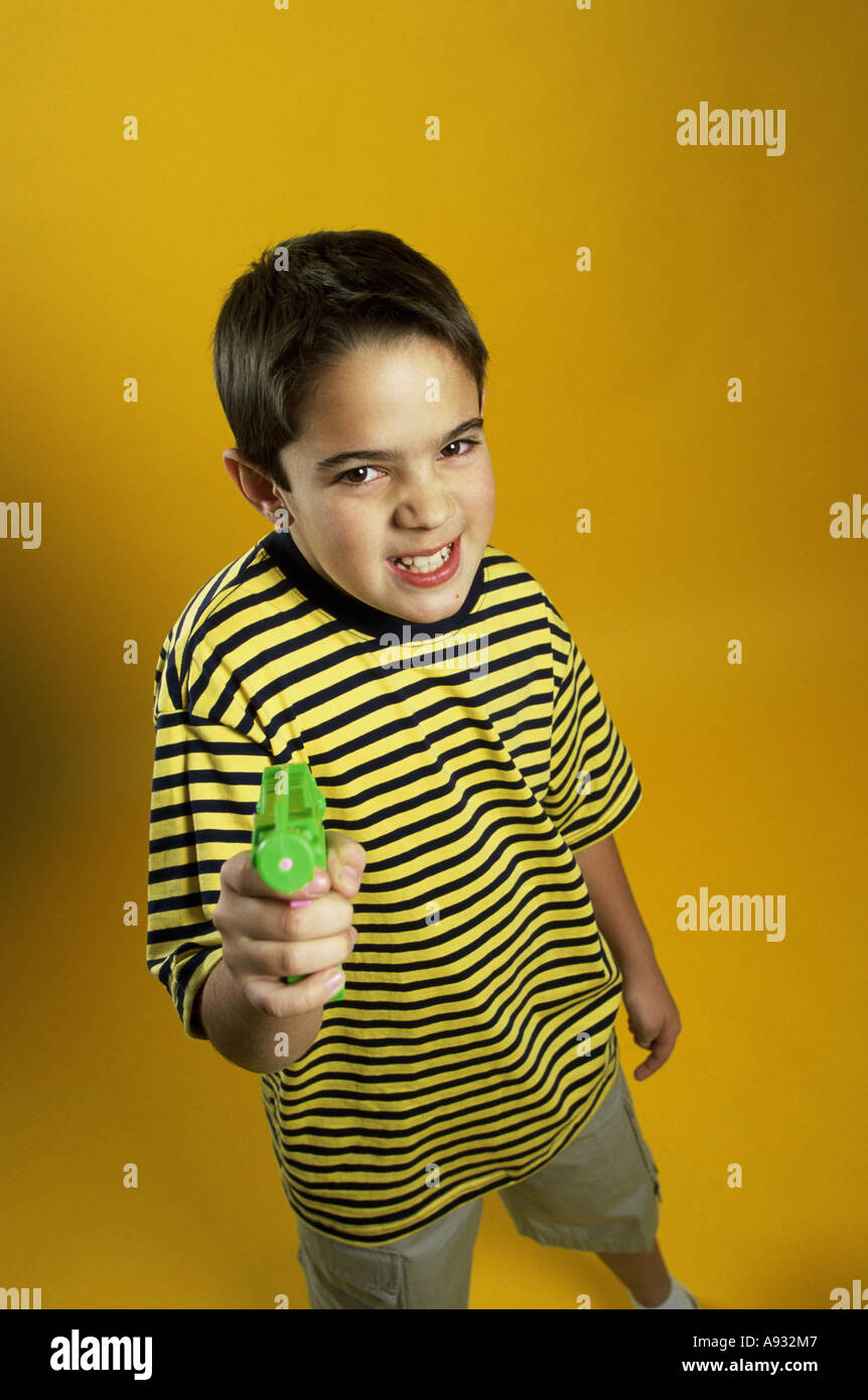 Boy with a toy gun hi-res stock photography and images - Alamy