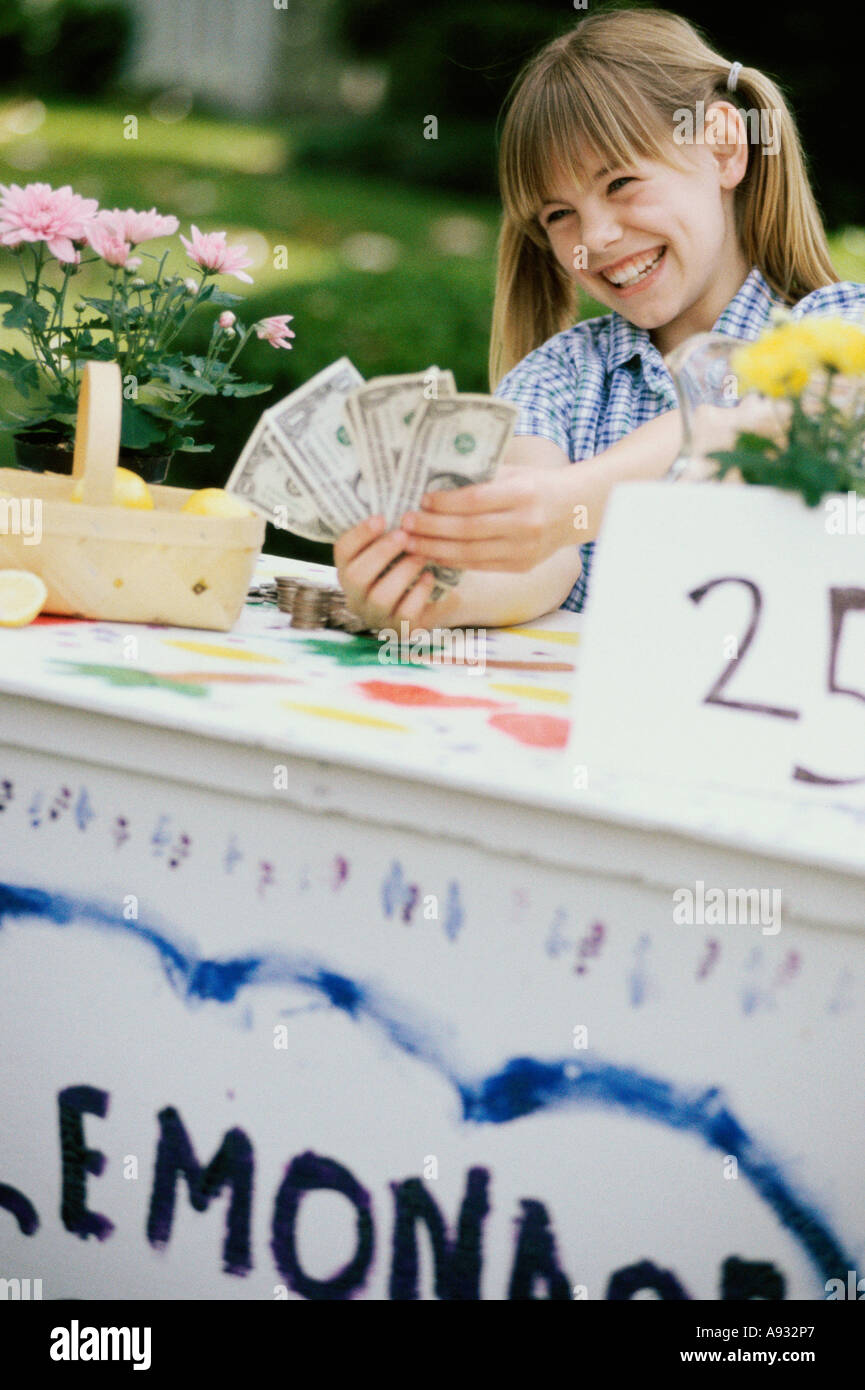 Girl making money at a lemonade stand Stock Photo - Alamy