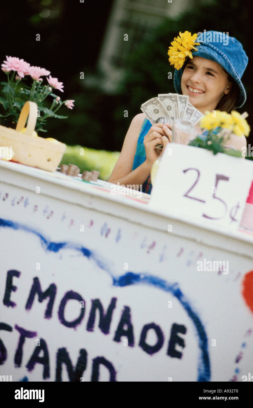 Girl making money at a lemonade stand Stock Photo - Alamy