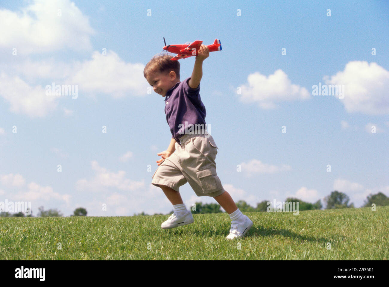 Boy playing with a model airplane Stock Photo - Alamy