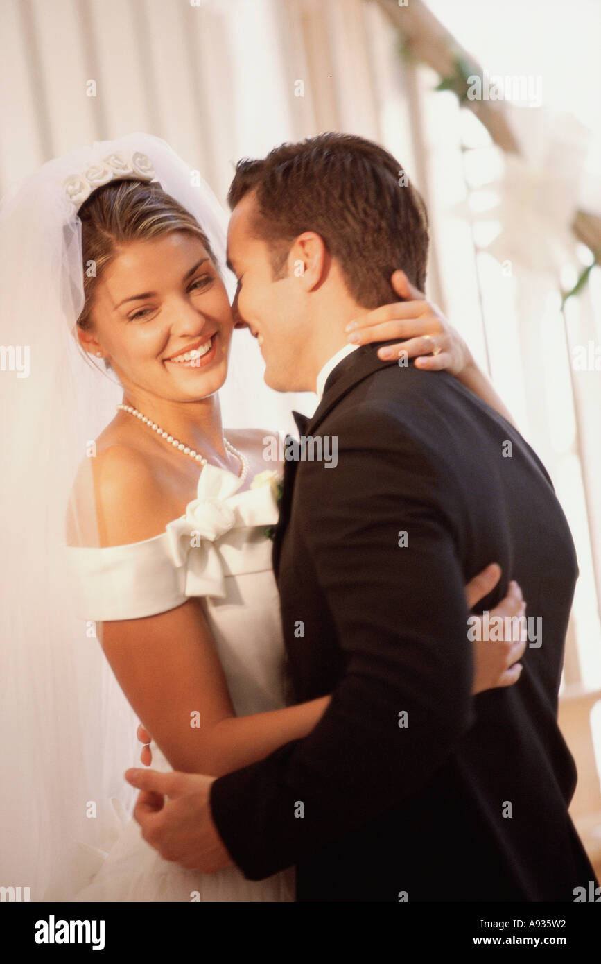 Side profile of a newlywed couple embracing each other Stock Photo - Alamy