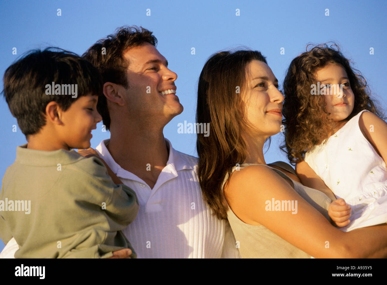 Close-up of parents with their son and daughter smiling Stock Photo - Alamy