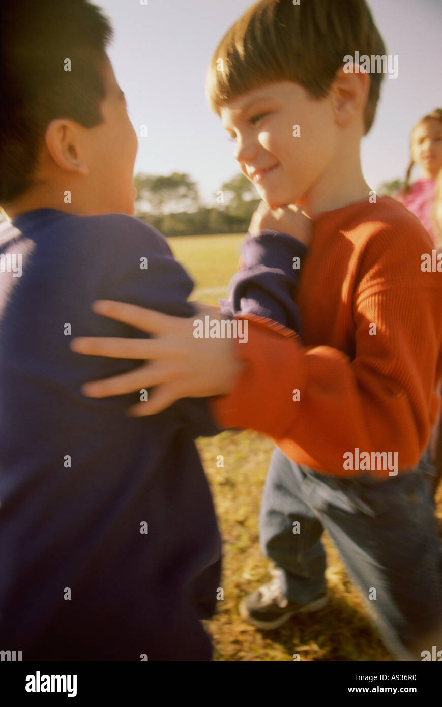 Side profile of two boys playing in a lawn Stock Photo - Alamy
