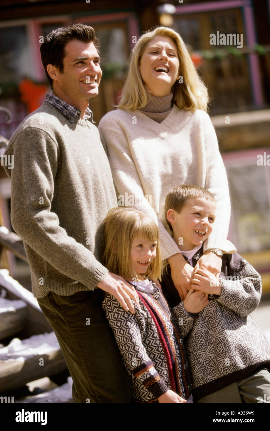 Parents standing with their children Stock Photo - Alamy