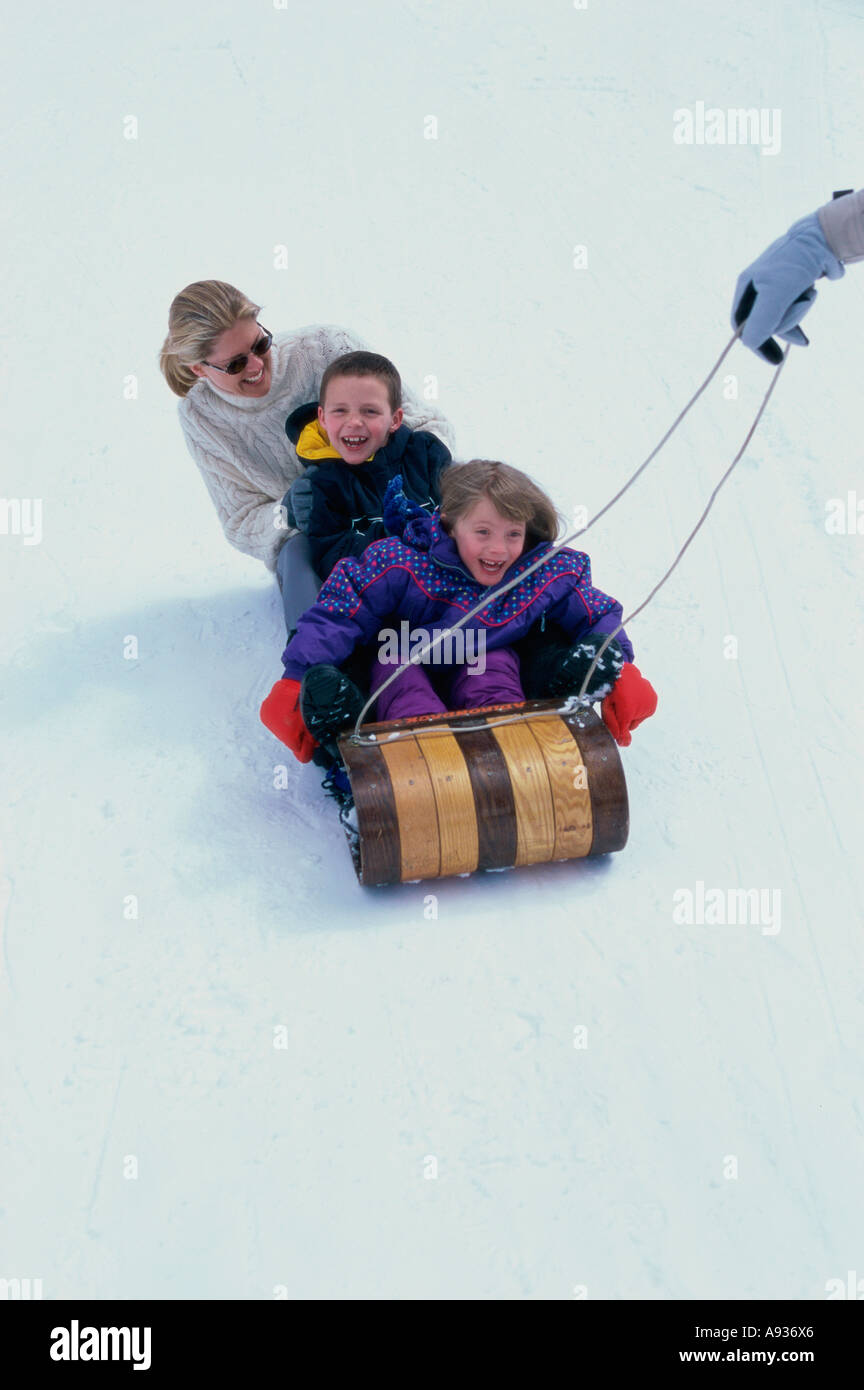 Father pulling his family on a sled Stock Photo - Alamy