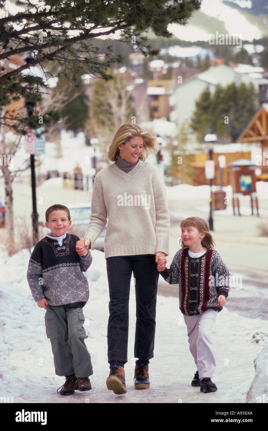 Mother walking with her two children Stock Photo - Alamy