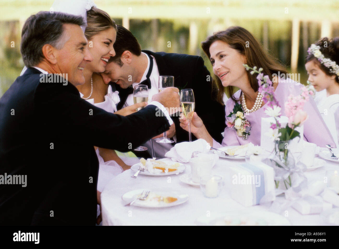 Newlywed couple and their parents at a table Stock Photo - Alamy