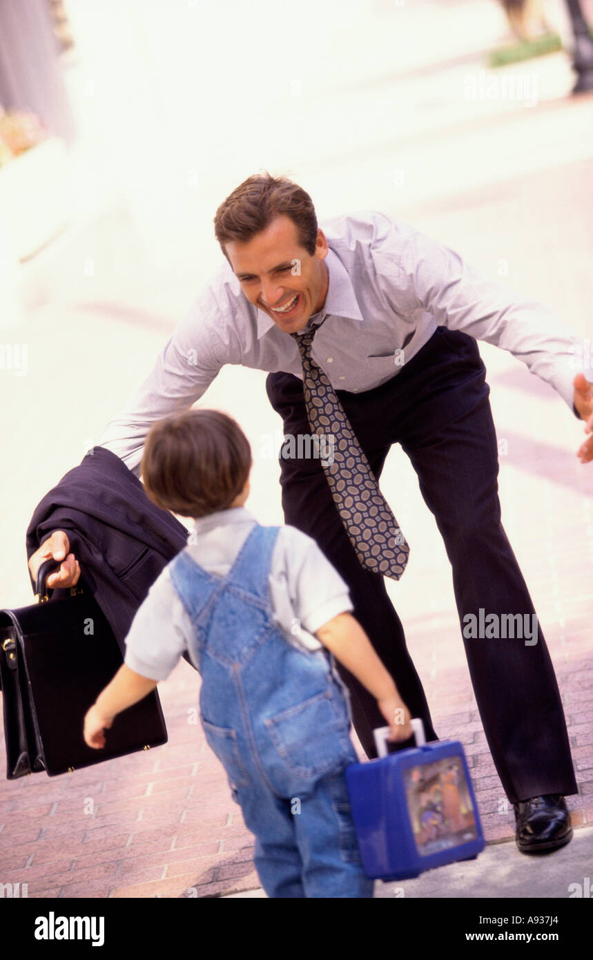 Rear view of a son running towards his father Stock Photo - Alamy