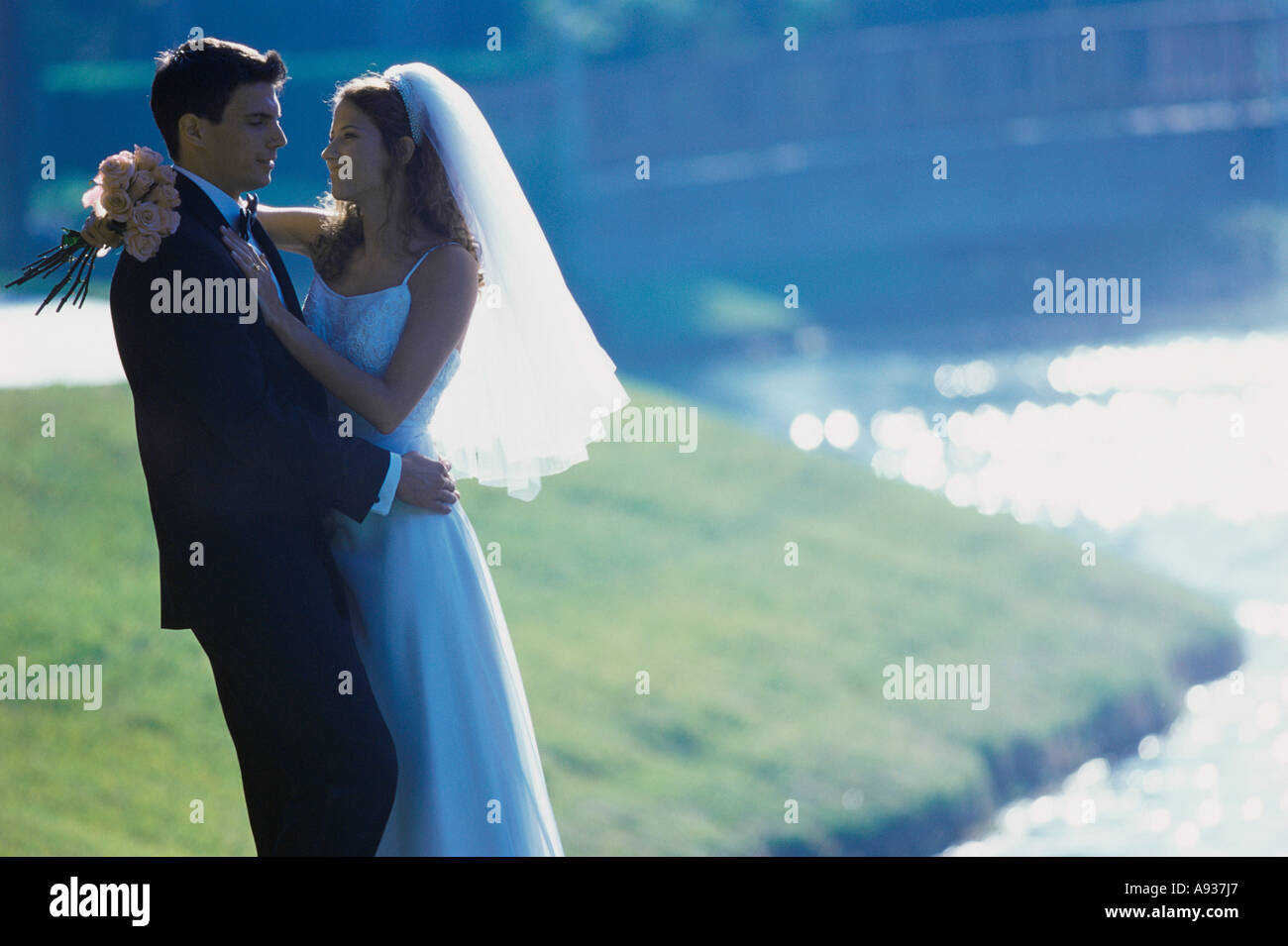 Side profile of a newlywed couple embracing each other Stock Photo - Alamy