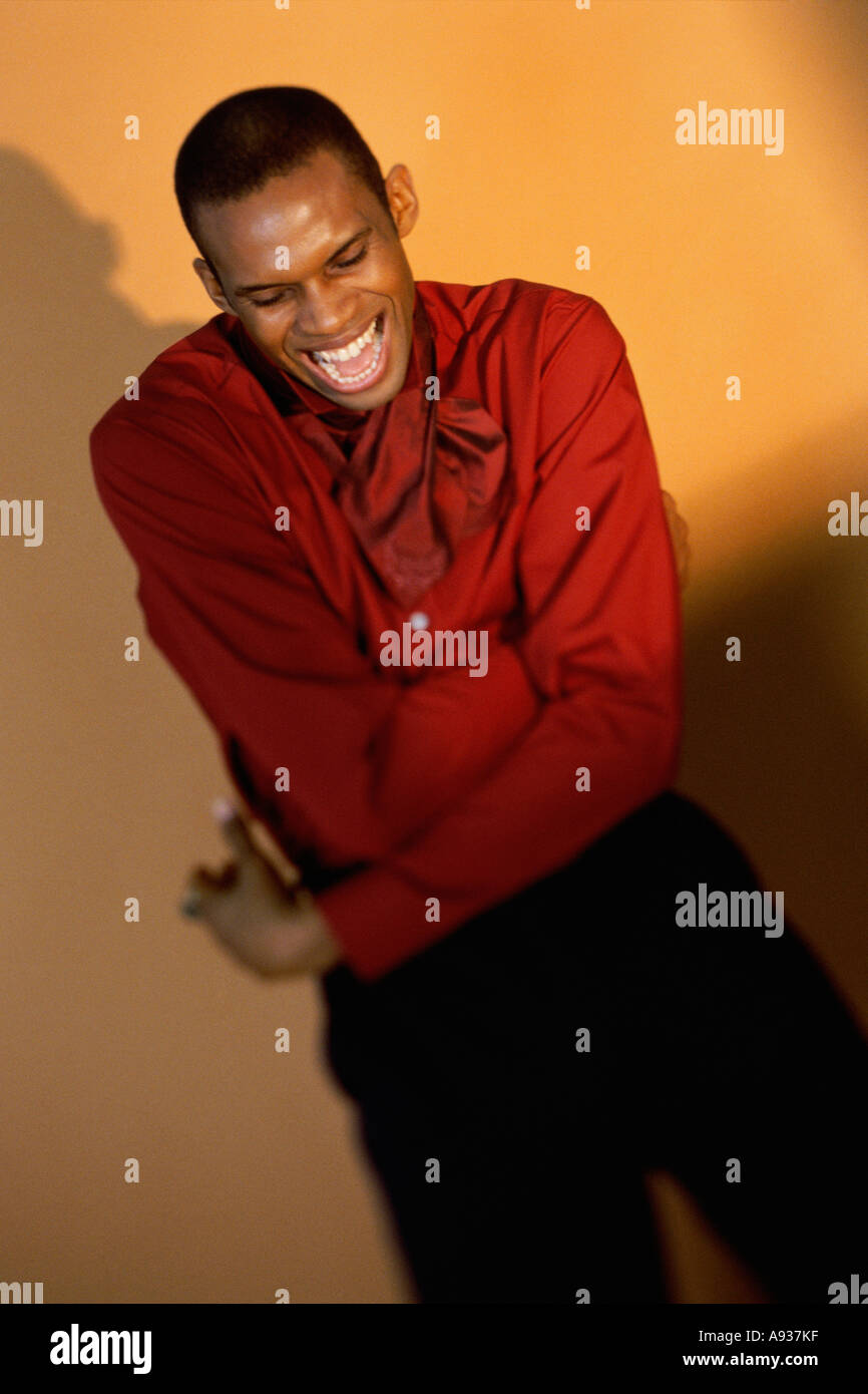 High angle view of a young man laughing with his arms crossed Stock ...