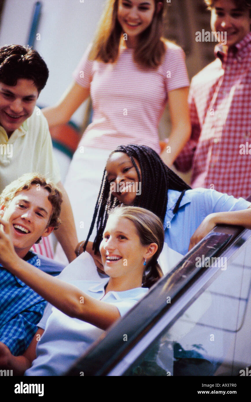 Group of teenagers standing on an escalator Stock Photo - Alamy