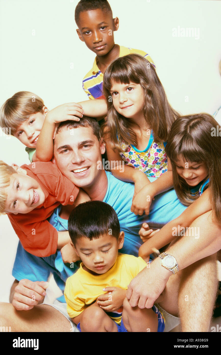 Portrait of a young man playing with children Stock Photo - Alamy