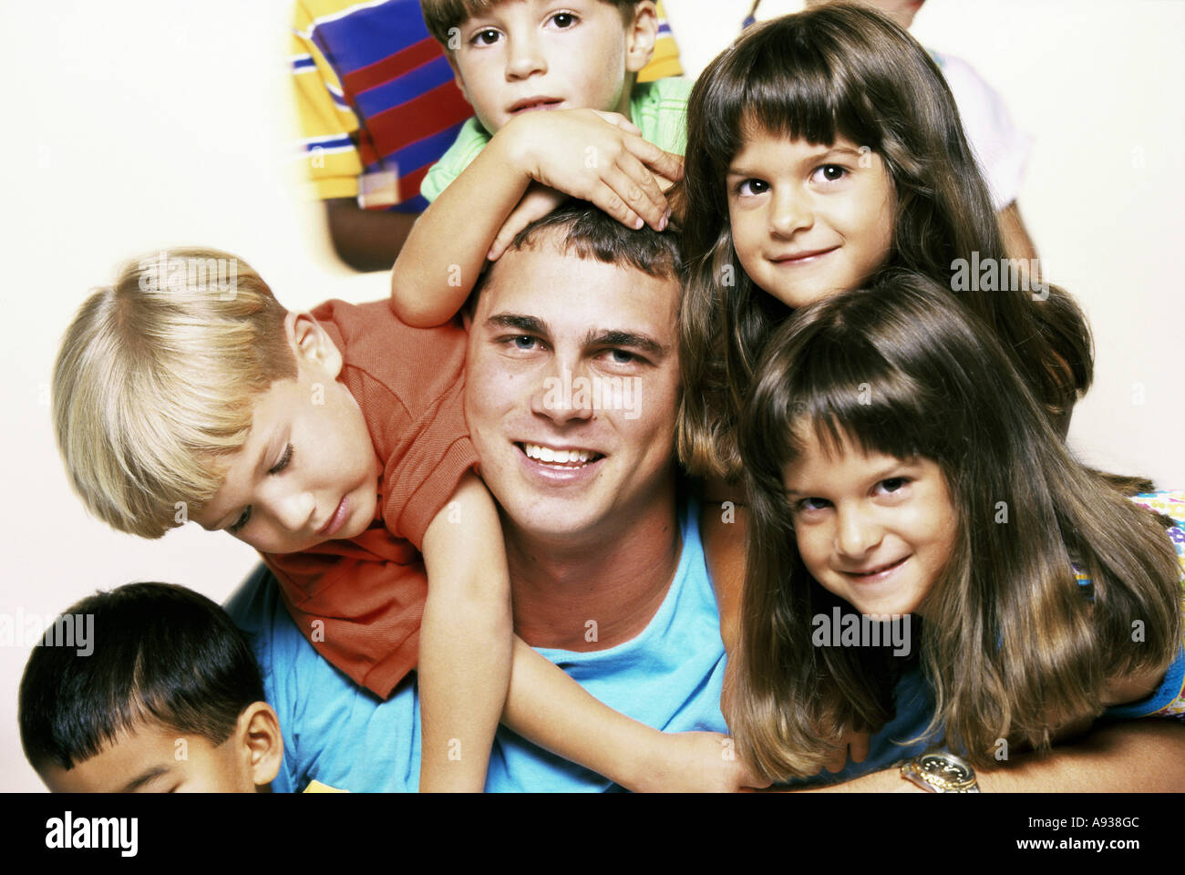 Portrait of a young man posing with children Stock Photo - Alamy