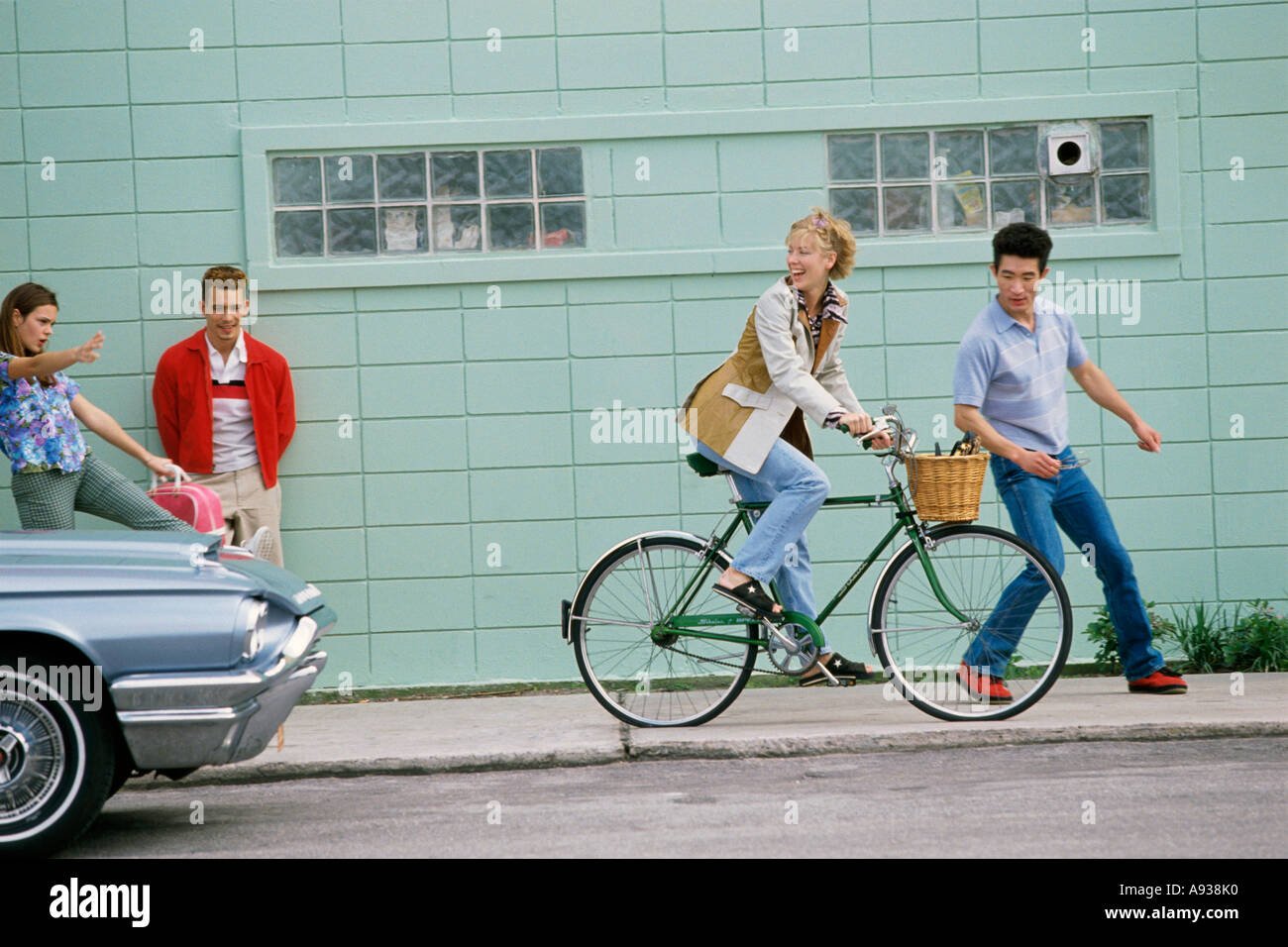 Side profile of a young woman riding a bicycle and looking back Stock ...