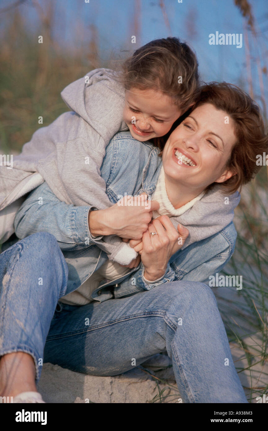 Daughter hugging her mother from behind Stock Photo - Alamy