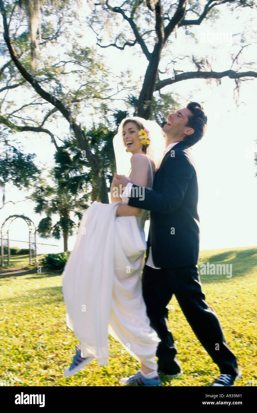 Side profile of a newlywed couple laughing Stock Photo - Alamy