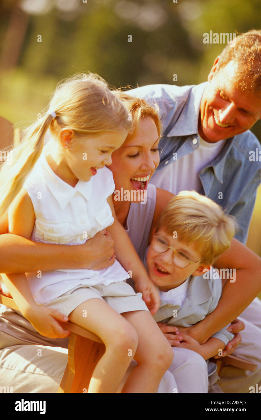 Parents and their two children laughing Stock Photo - Alamy