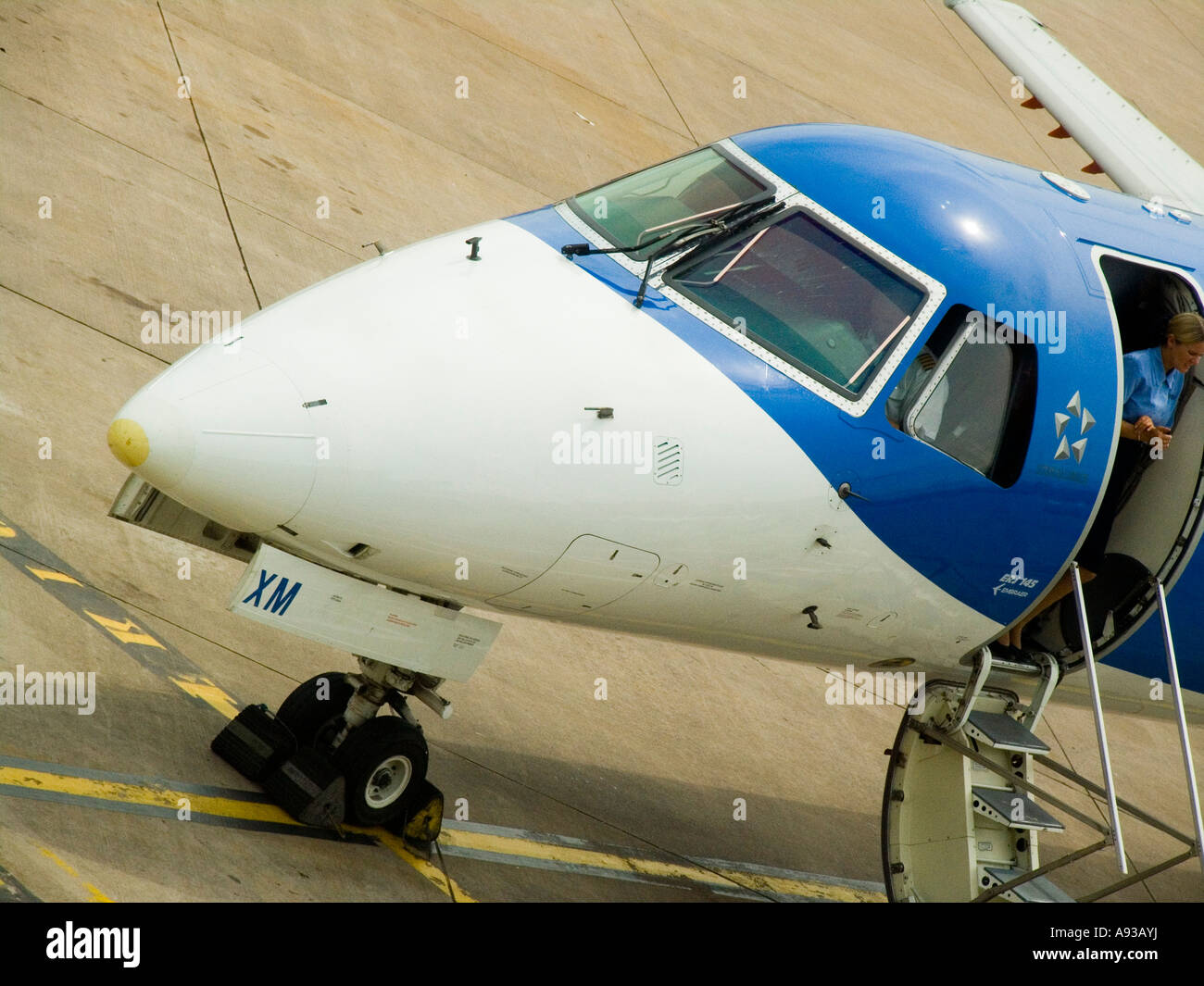 Passengers disembarking from a small regional jet aircraft on the ...