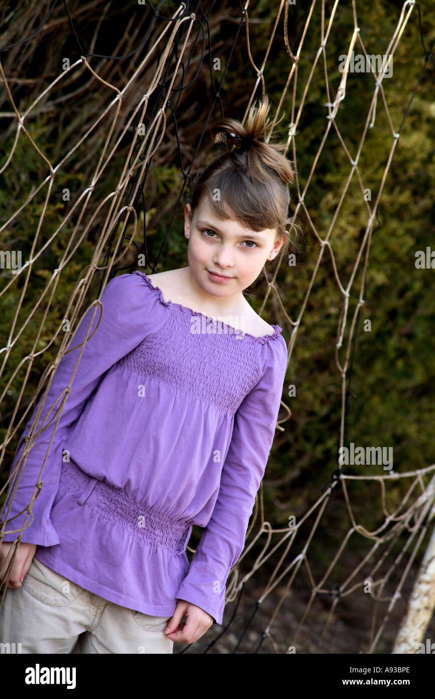 Vertical colour portrait of pretty young girl posing looking cheeky ...