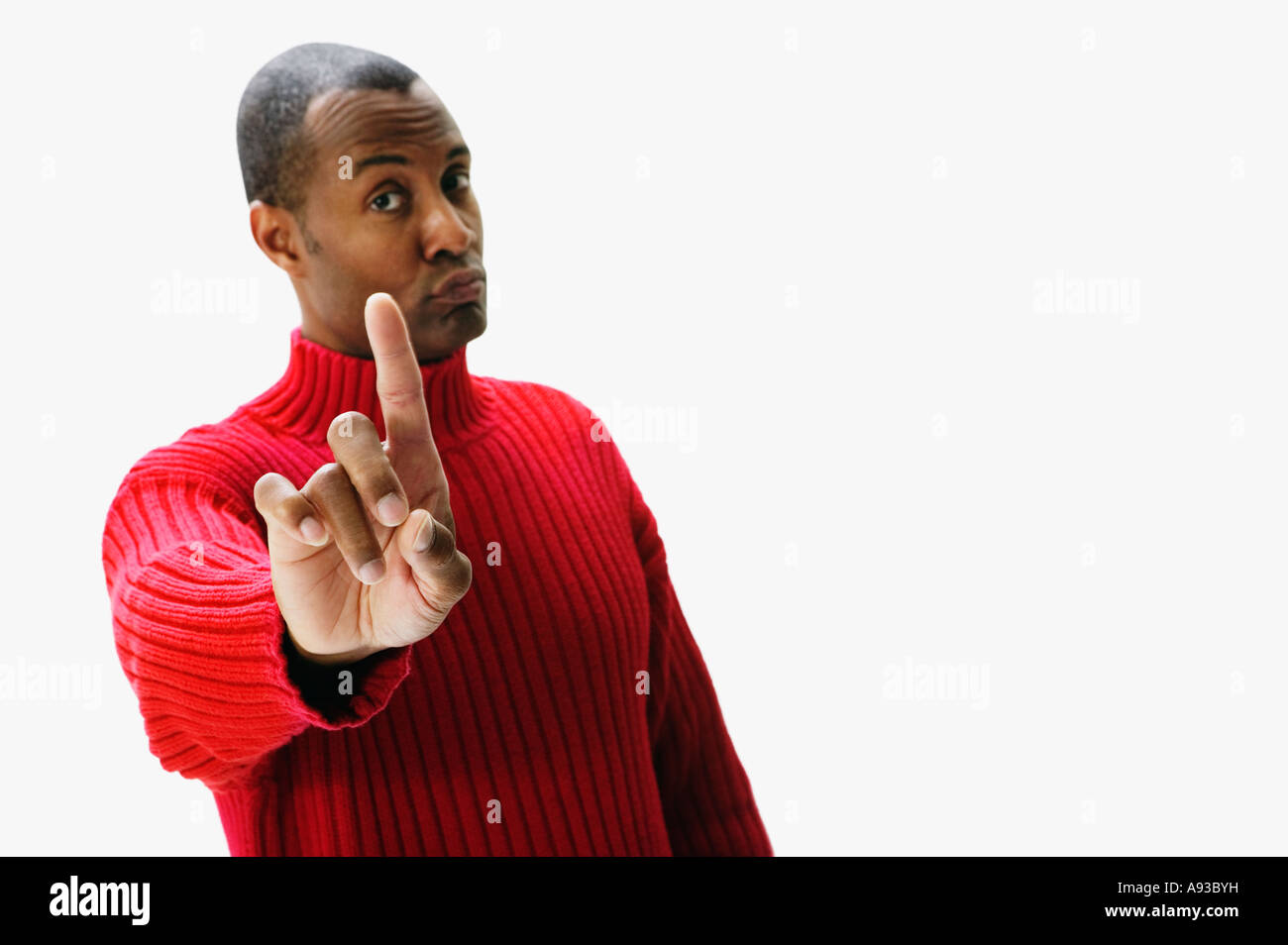 African man holding index finger up and pursing lips Stock Photo - Alamy